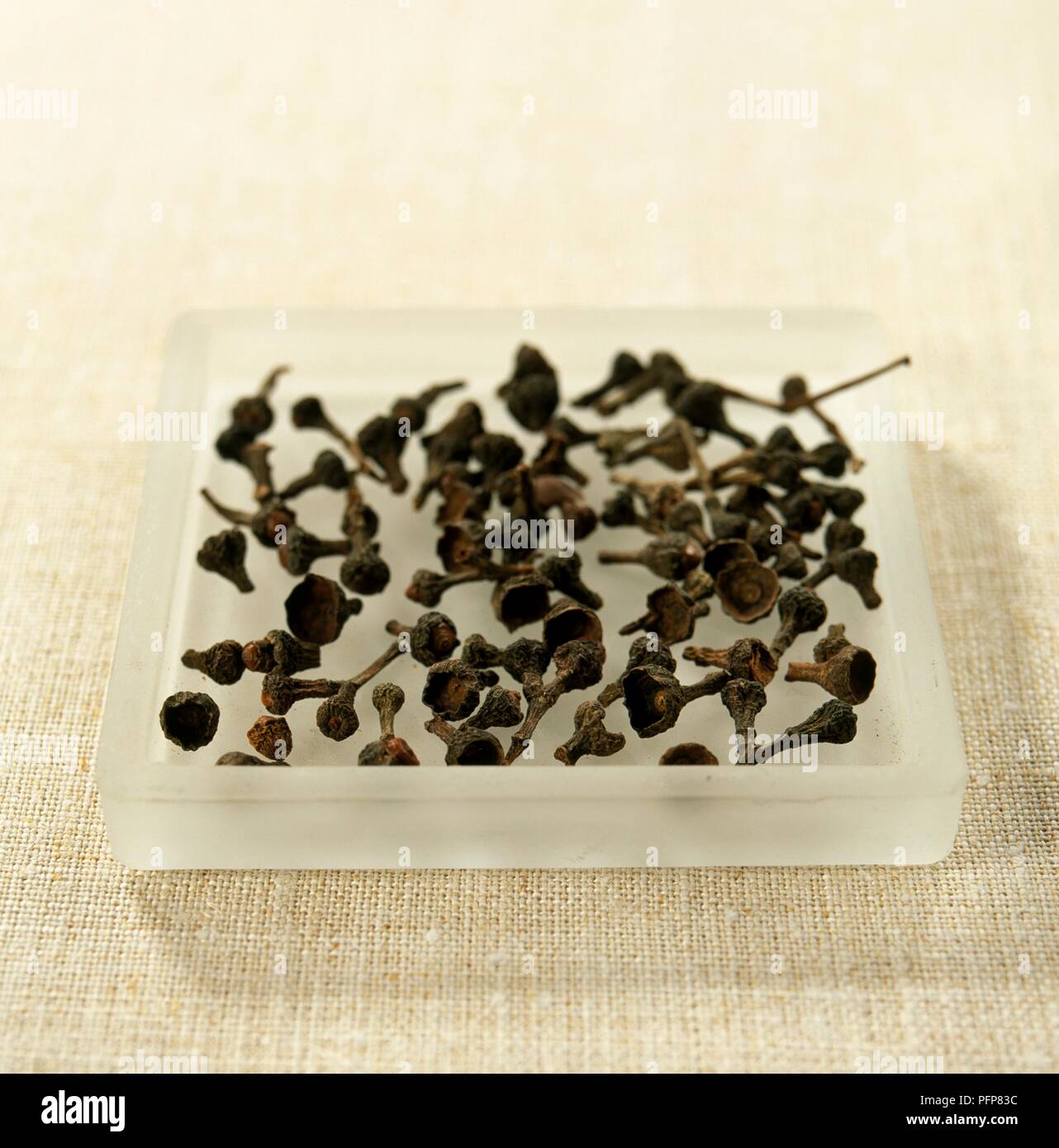Cassia (Cinnamomum cassia), dried buds in frosted glass dish Stock ...