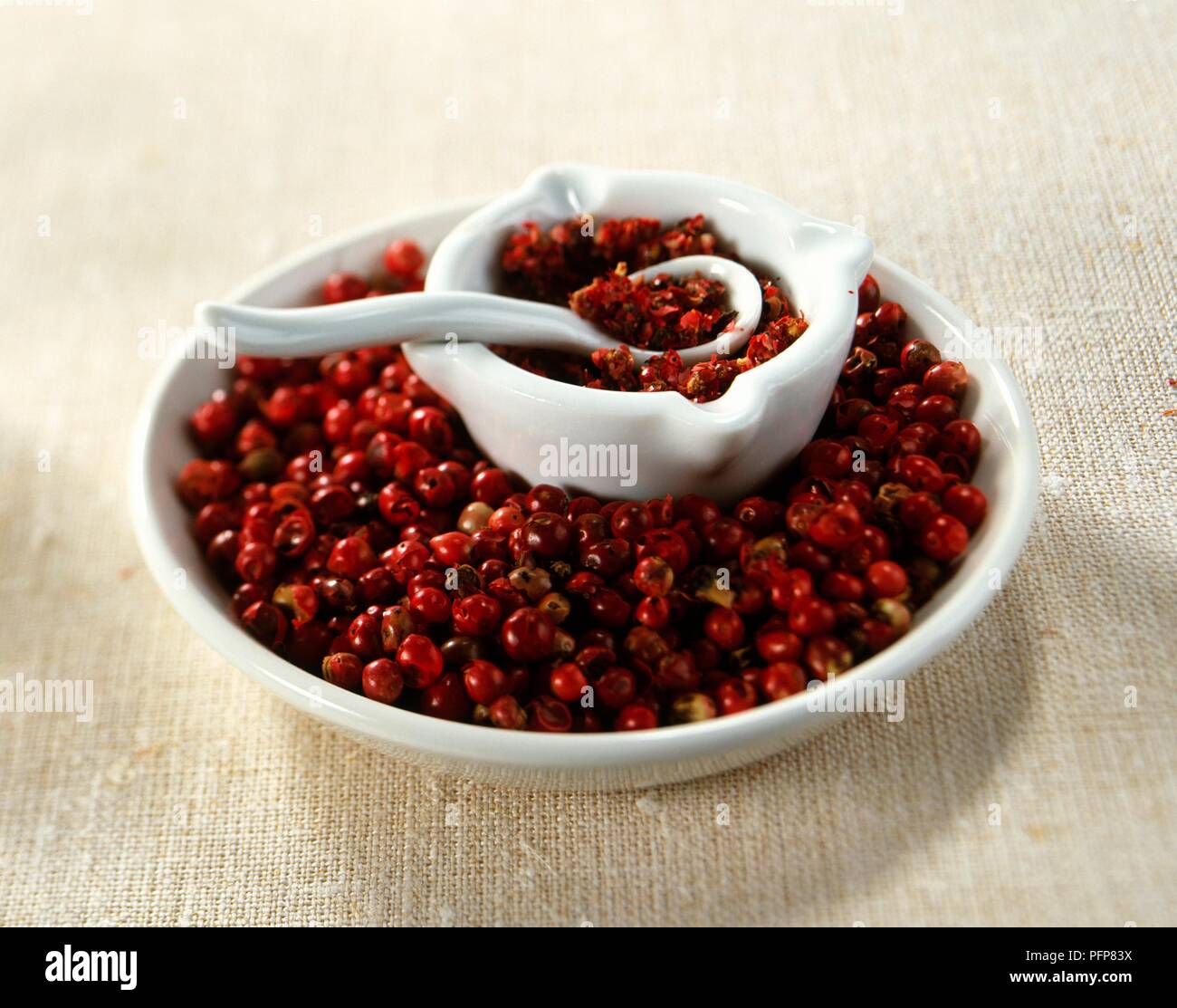 Pink Pepper (Schinus terebinthifolius), whole red berries in bowl and ...