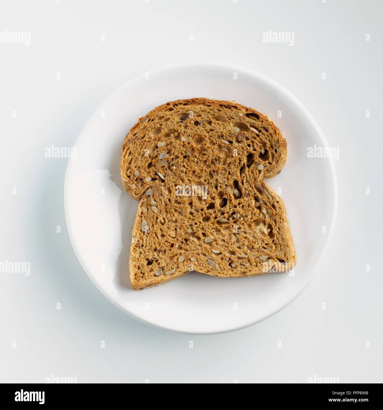 Slice of seeded brown bread Stock Photo - Alamy