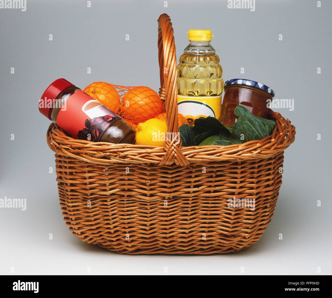 Wicker basket full of groceries, side view Stock Photo - Alamy
