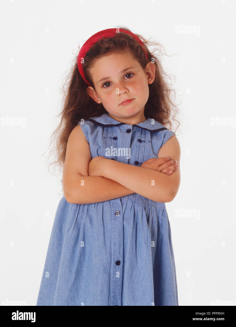 Girl with her arms crossed Stock Photo - Alamy