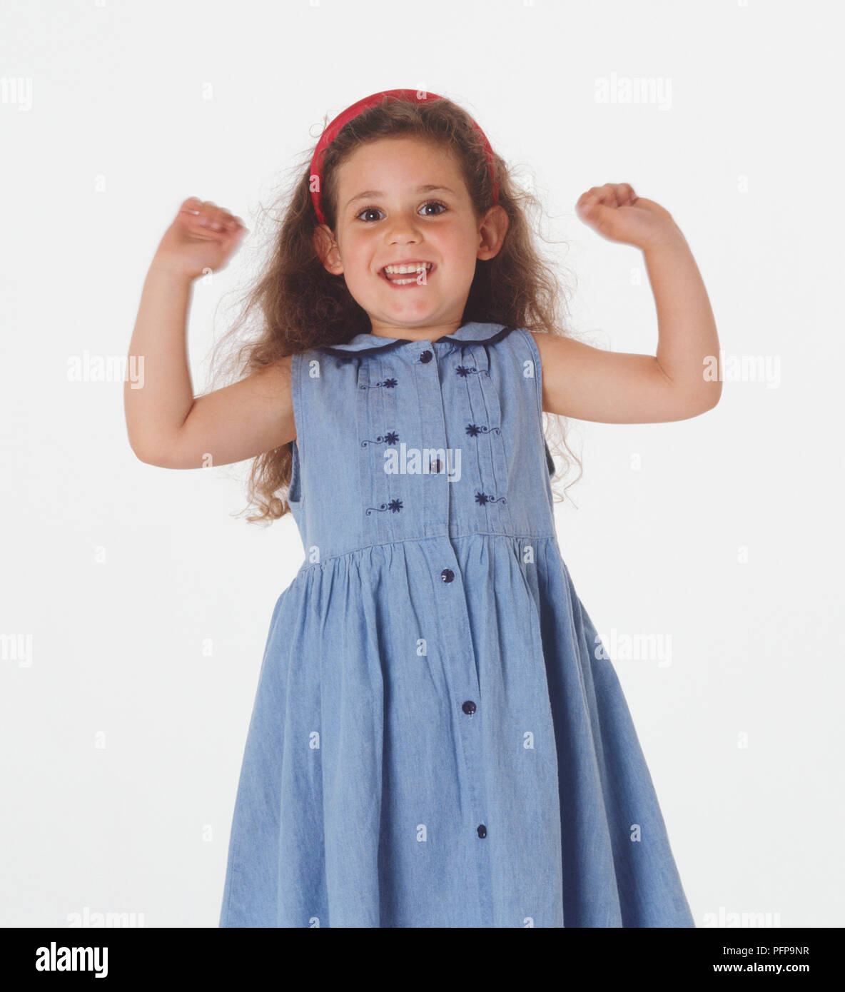 Girl with arms up Stock Photo - Alamy