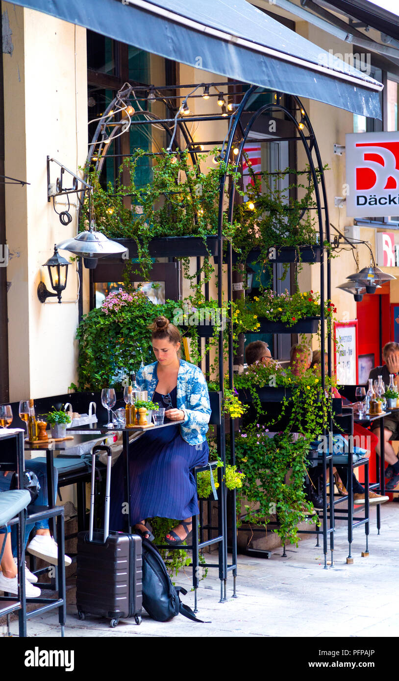 Woman sitting outside of a cafe in Sofo, Sodermalm, Stockholm, Sweden ...