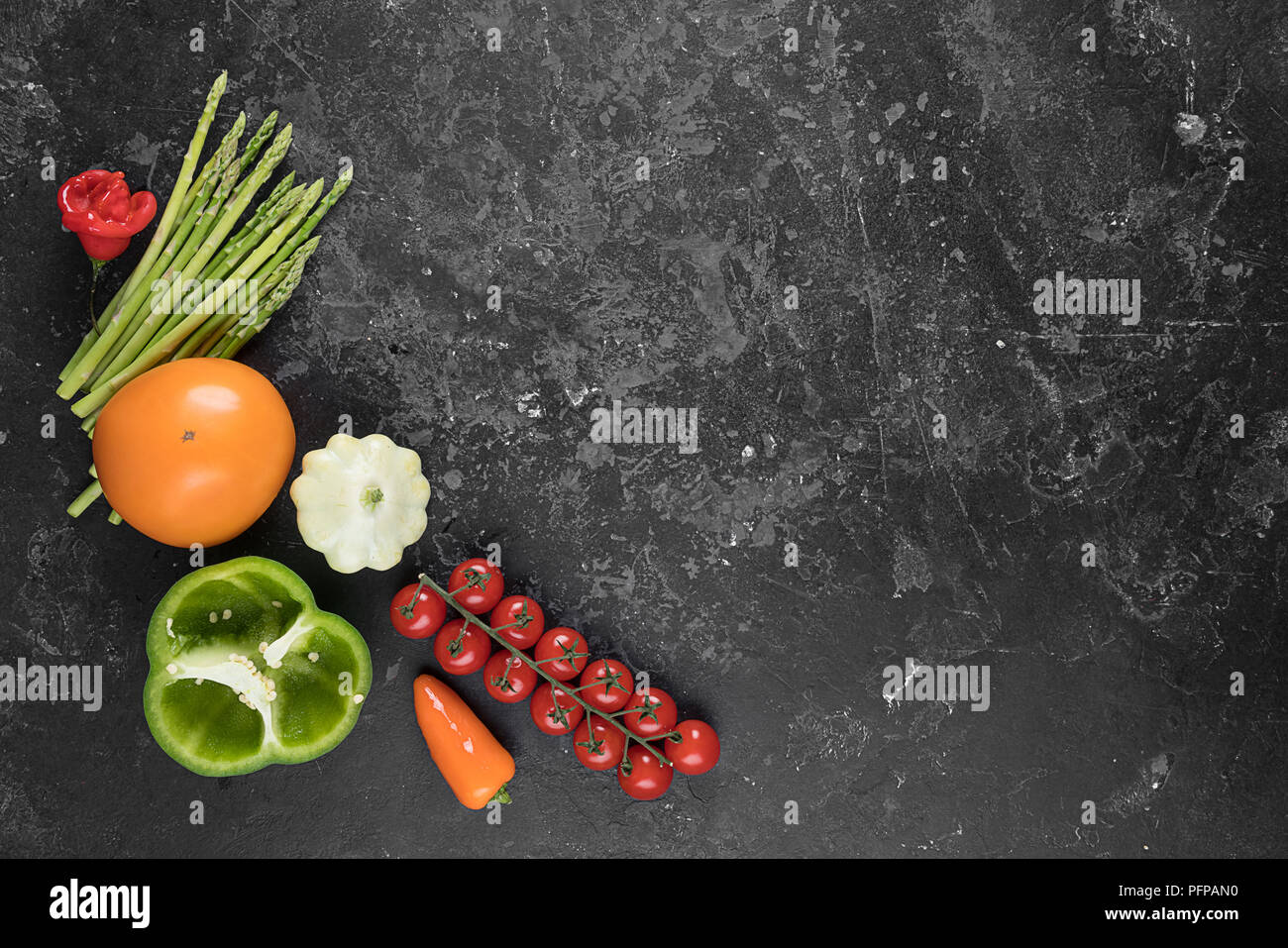 Food background. Fresh farmer vegetables at dark beton table. Space for ...