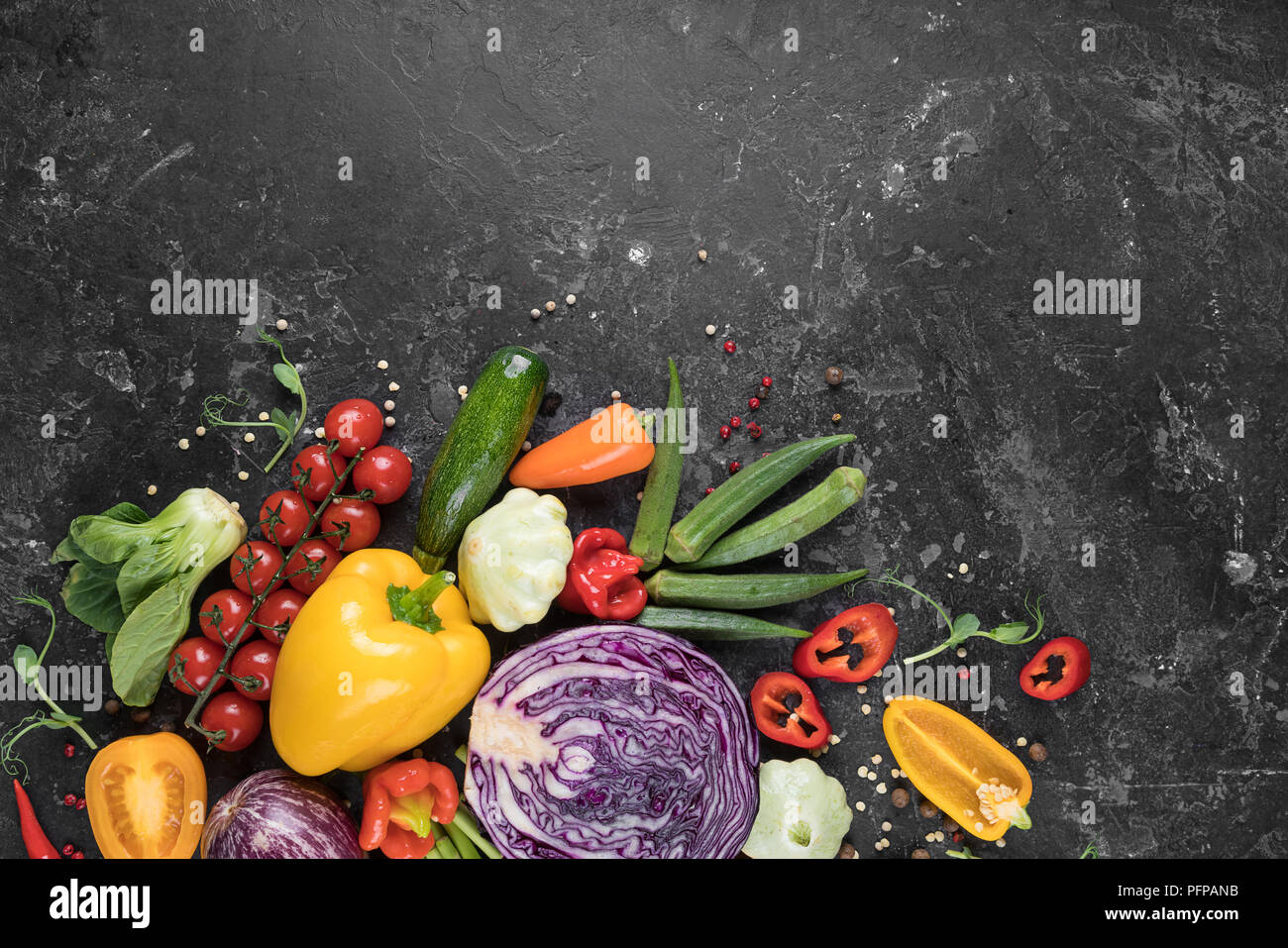 Food background. Fresh farmer vegetables at dark beton table. Space for ...