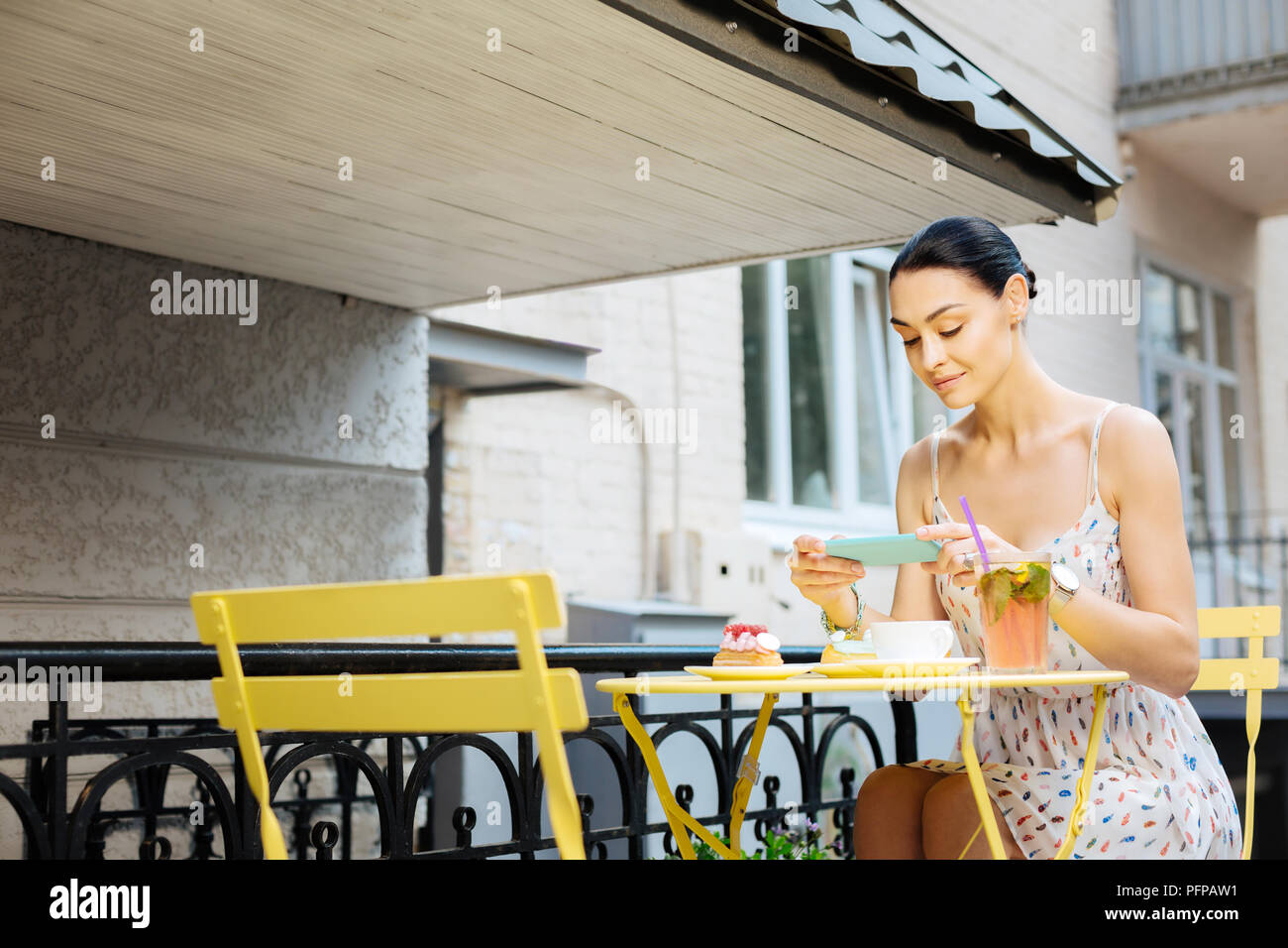 Famous food blogger smiling while taking photos of her lunch Stock ...