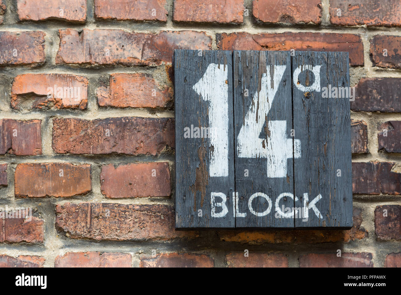 Wooden sign for block 14a on a brick wall in the former Nazi ...