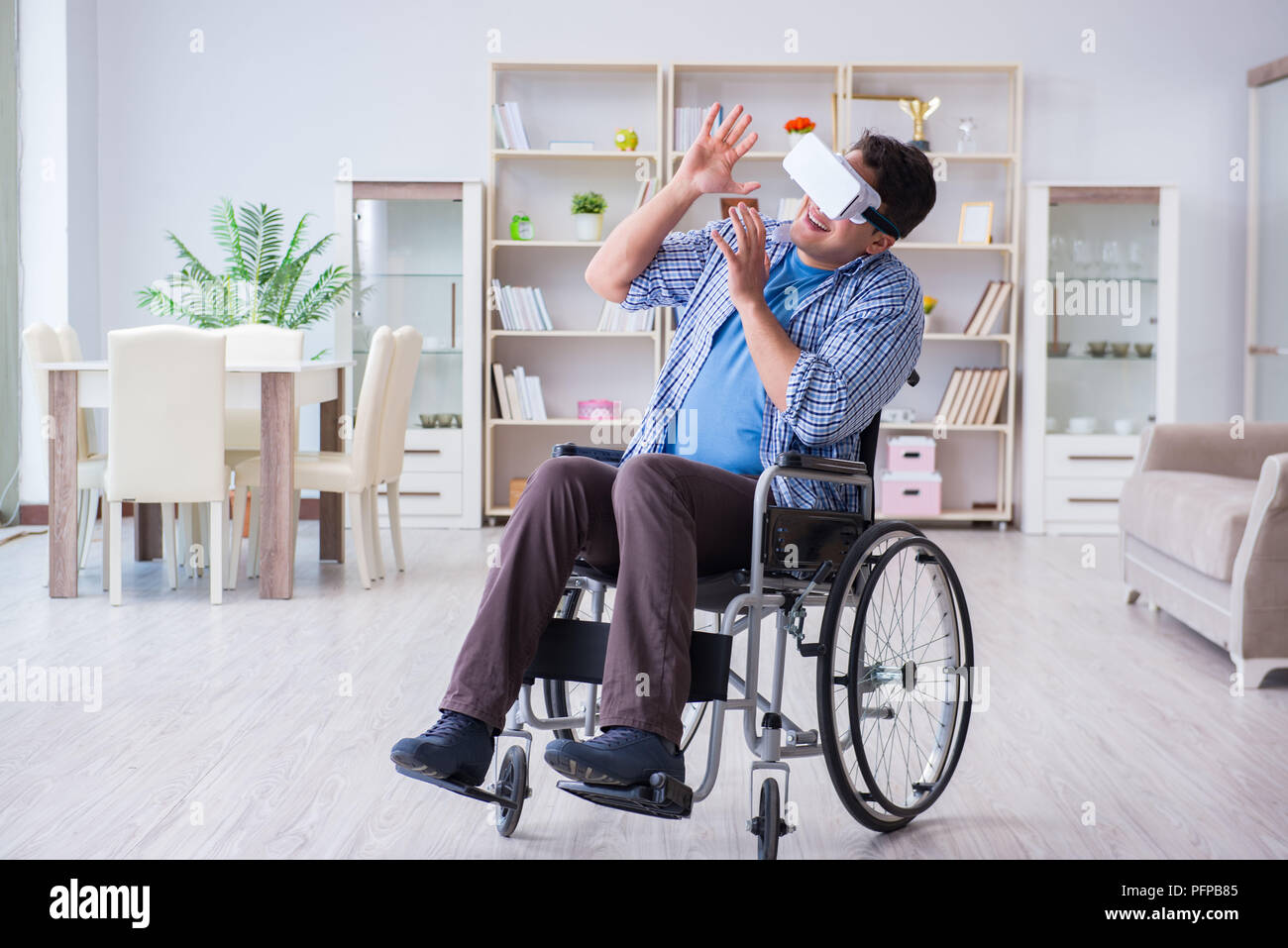 Disabled man studying with virtual reality glasses Stock Photo - Alamy