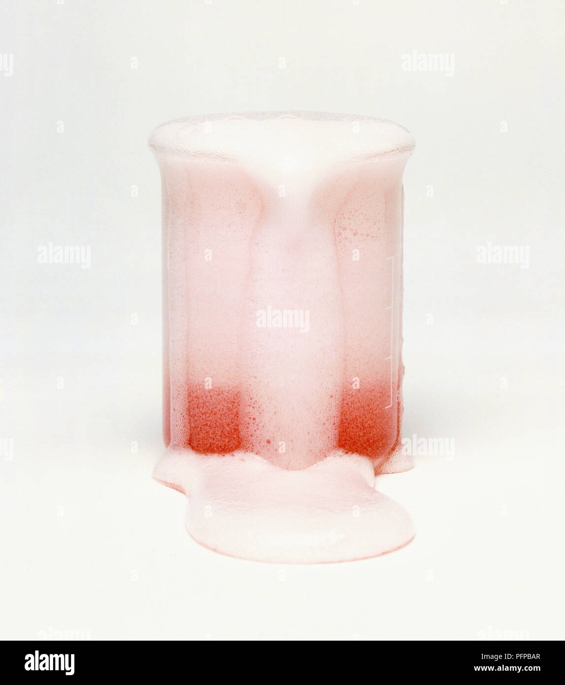 Carbonated drink overflowing from beaker after mixing with sugar Stock ...