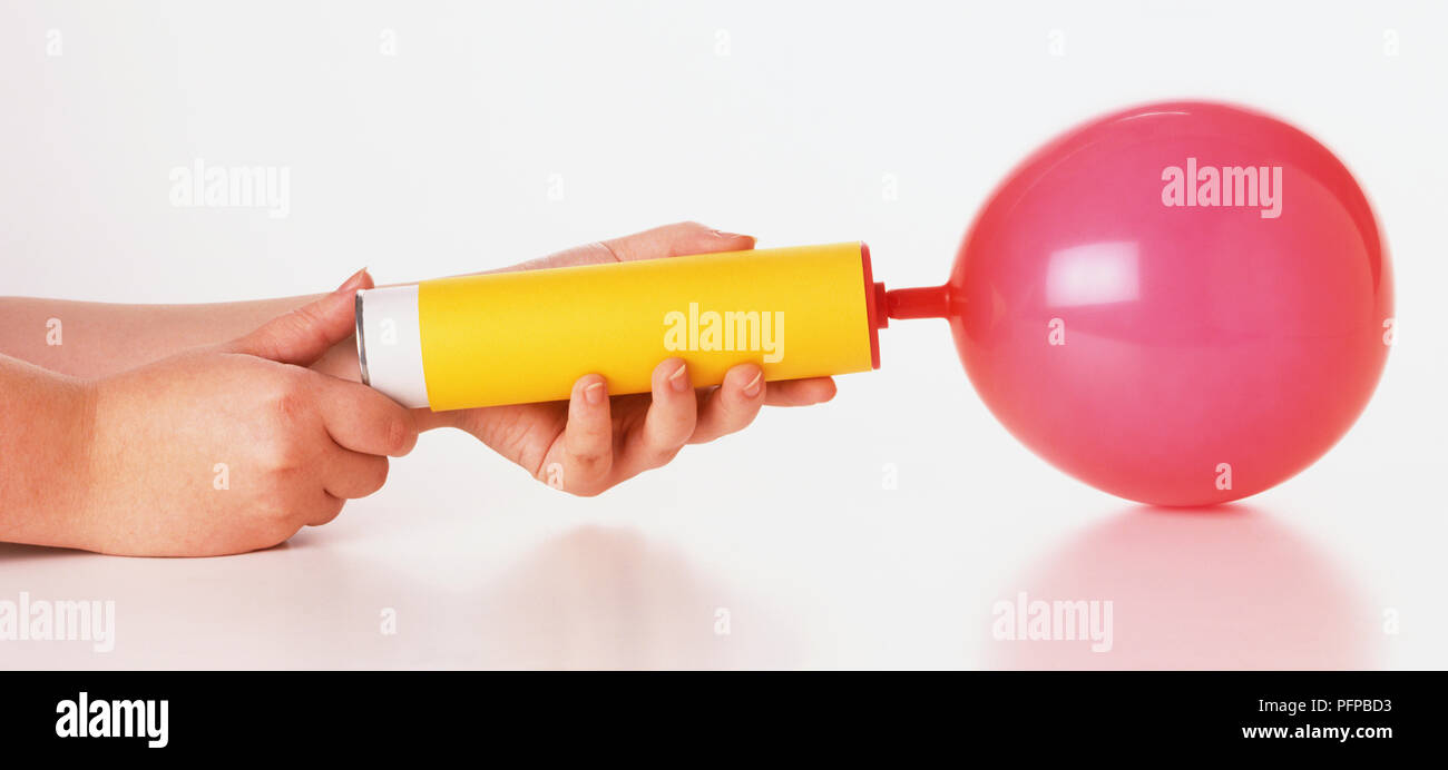 Person inflating balloon using handheld pump Stock Photo - Alamy