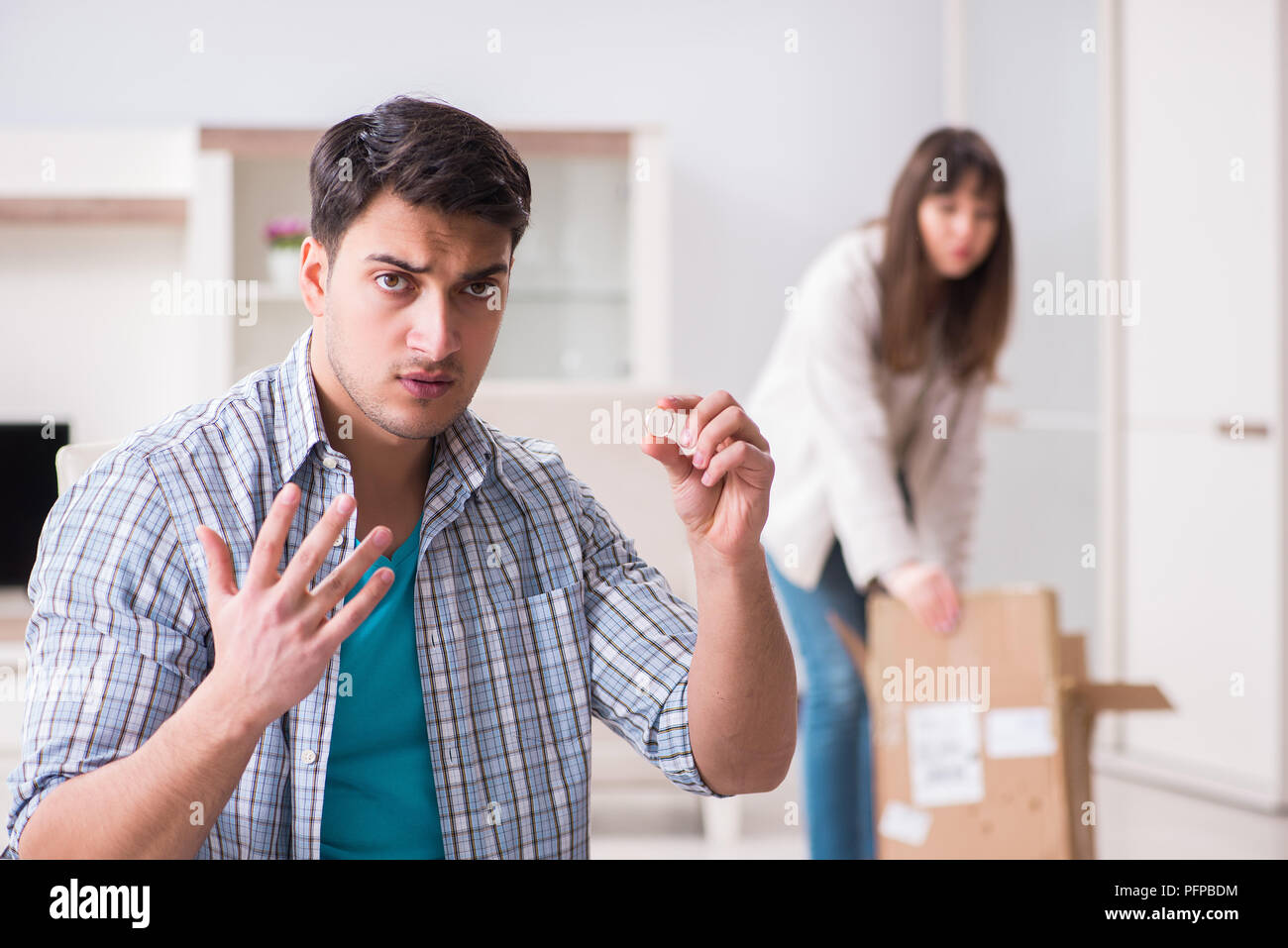 Woman evicting man from house during family conflict Stock Photo - Alamy