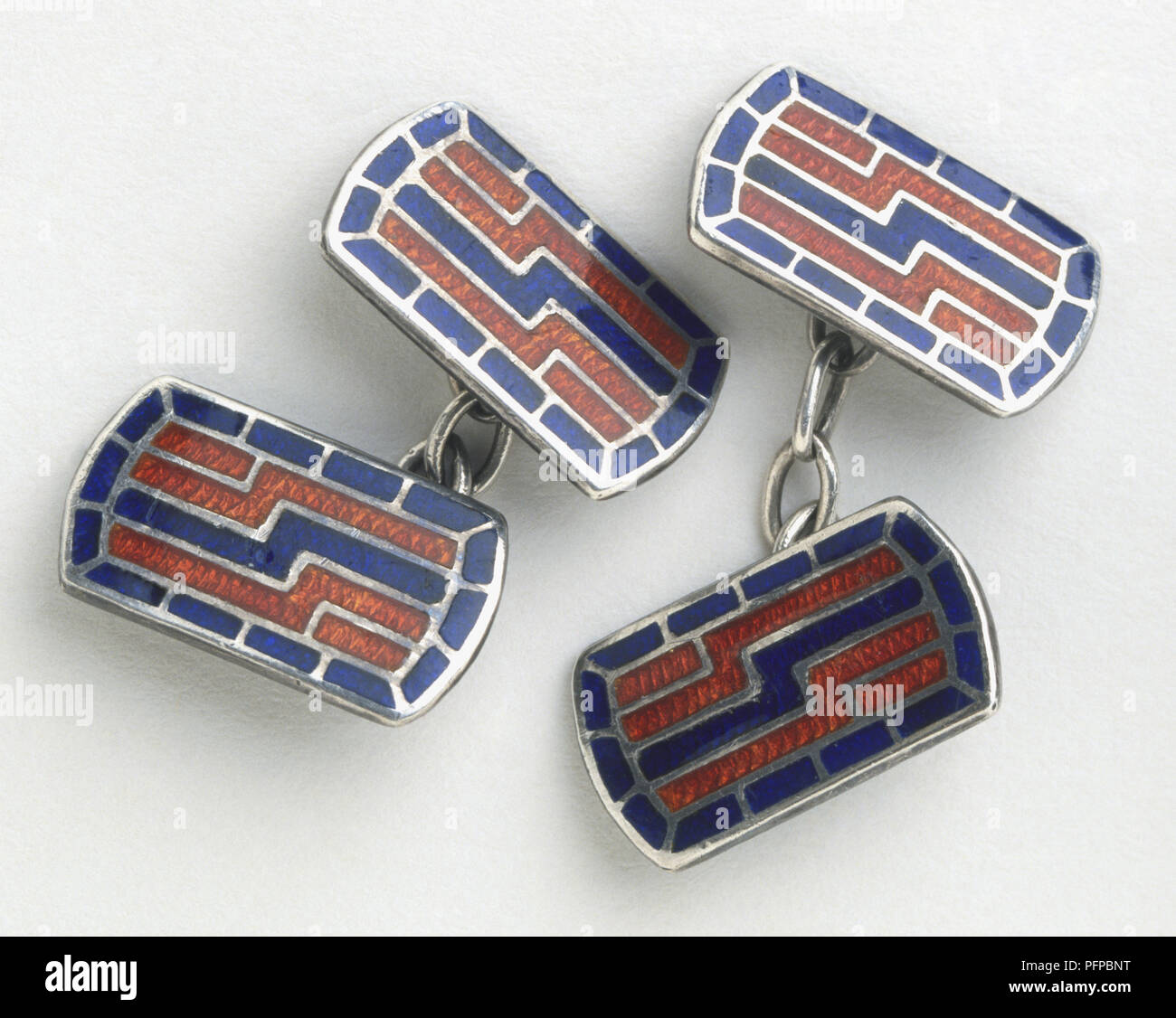 Pair of cufflinks in a blue and red geometric design Stock Photo - Alamy