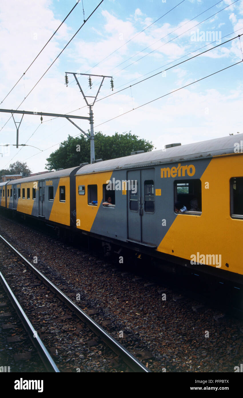South Africa, commuter Metro train on track and electric cable above ...