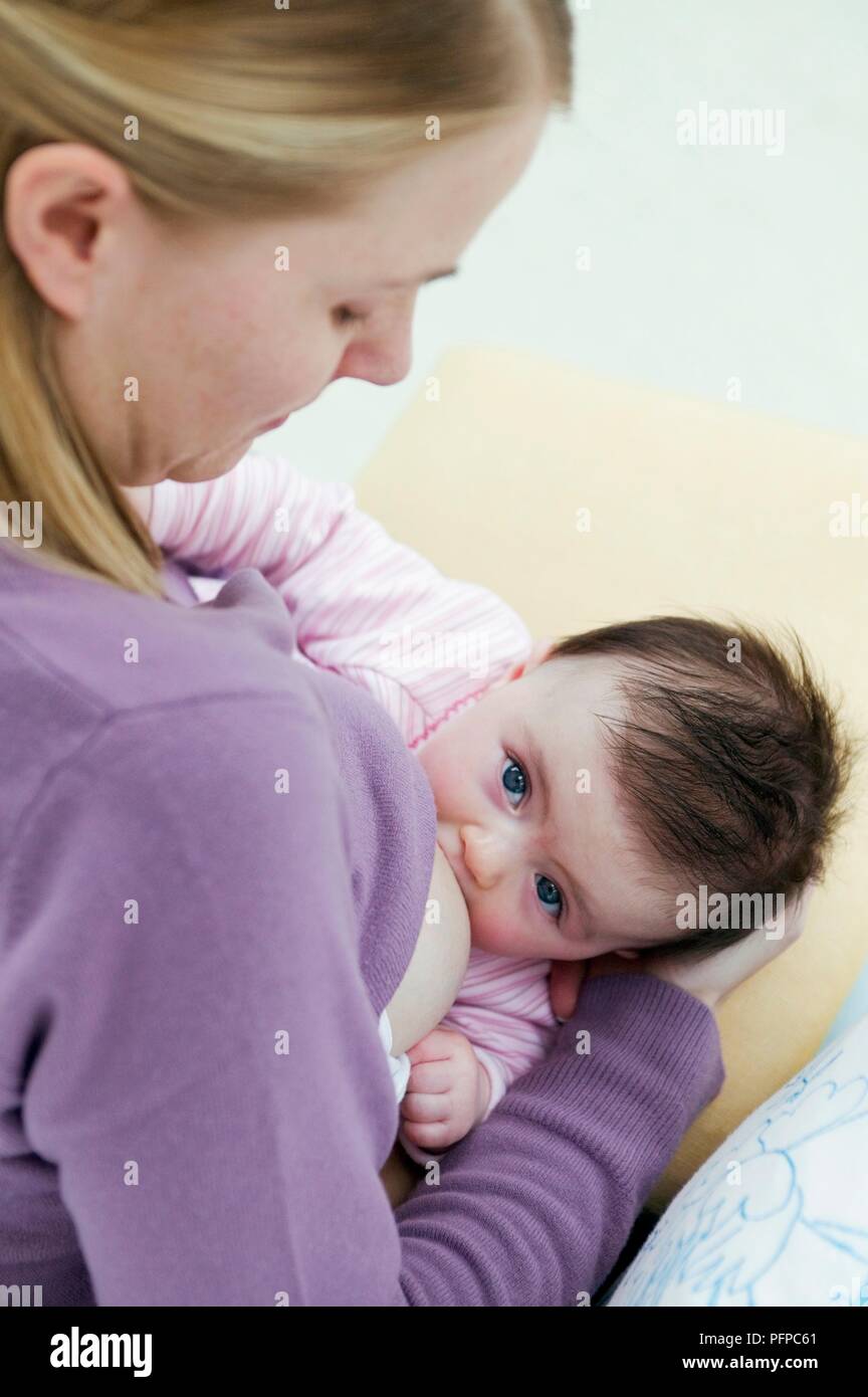 Woman breastfeeding her baby hi-res stock photography and images - Alamy