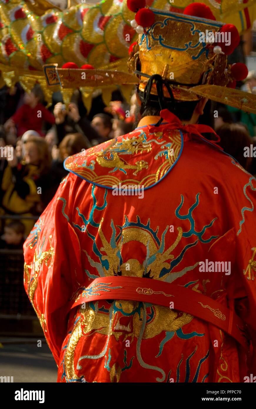 England, London, Soho, Chinatown, man in traditional Chinese red robe ...