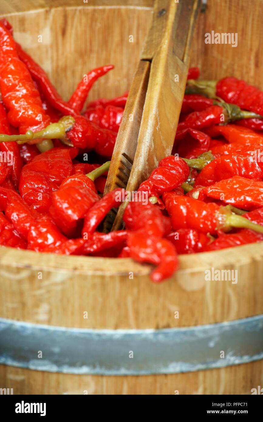 England, London, Borough Market, pickled red peppers in wooden bucket ...