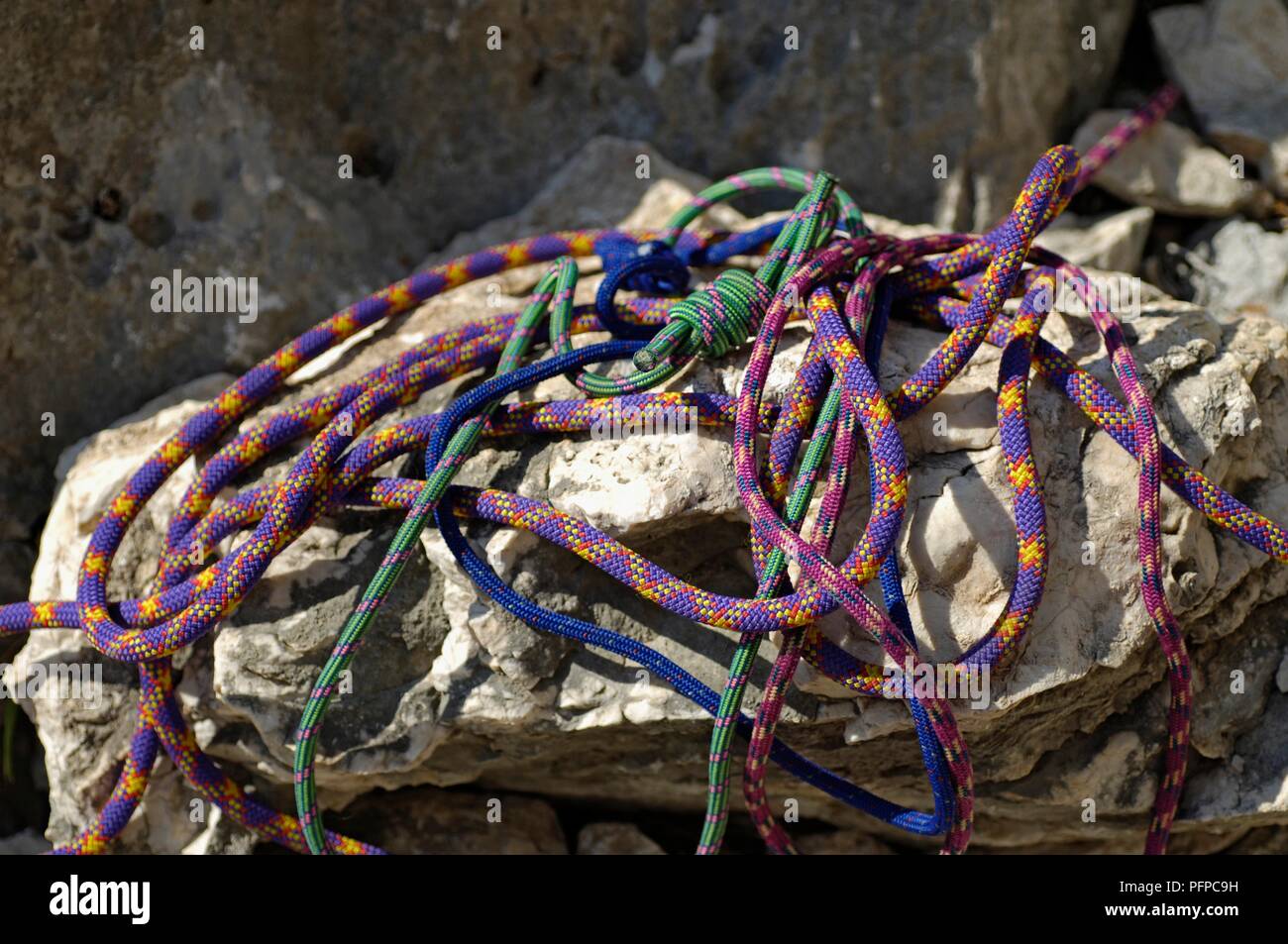 Four climbing ropes on rock Stock Photo - Alamy