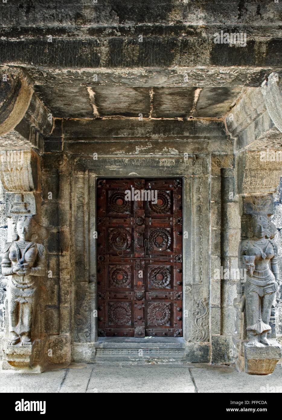 India, Tamil Nadu, Padmanabhapuram Palace, wooden temple door flanked ...