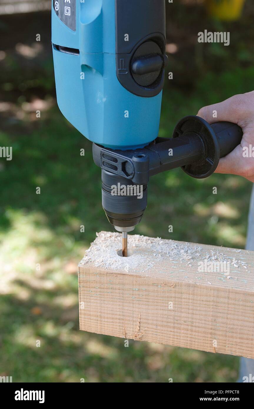 Drilling hole into timber, close-up Stock Photo - Alamy