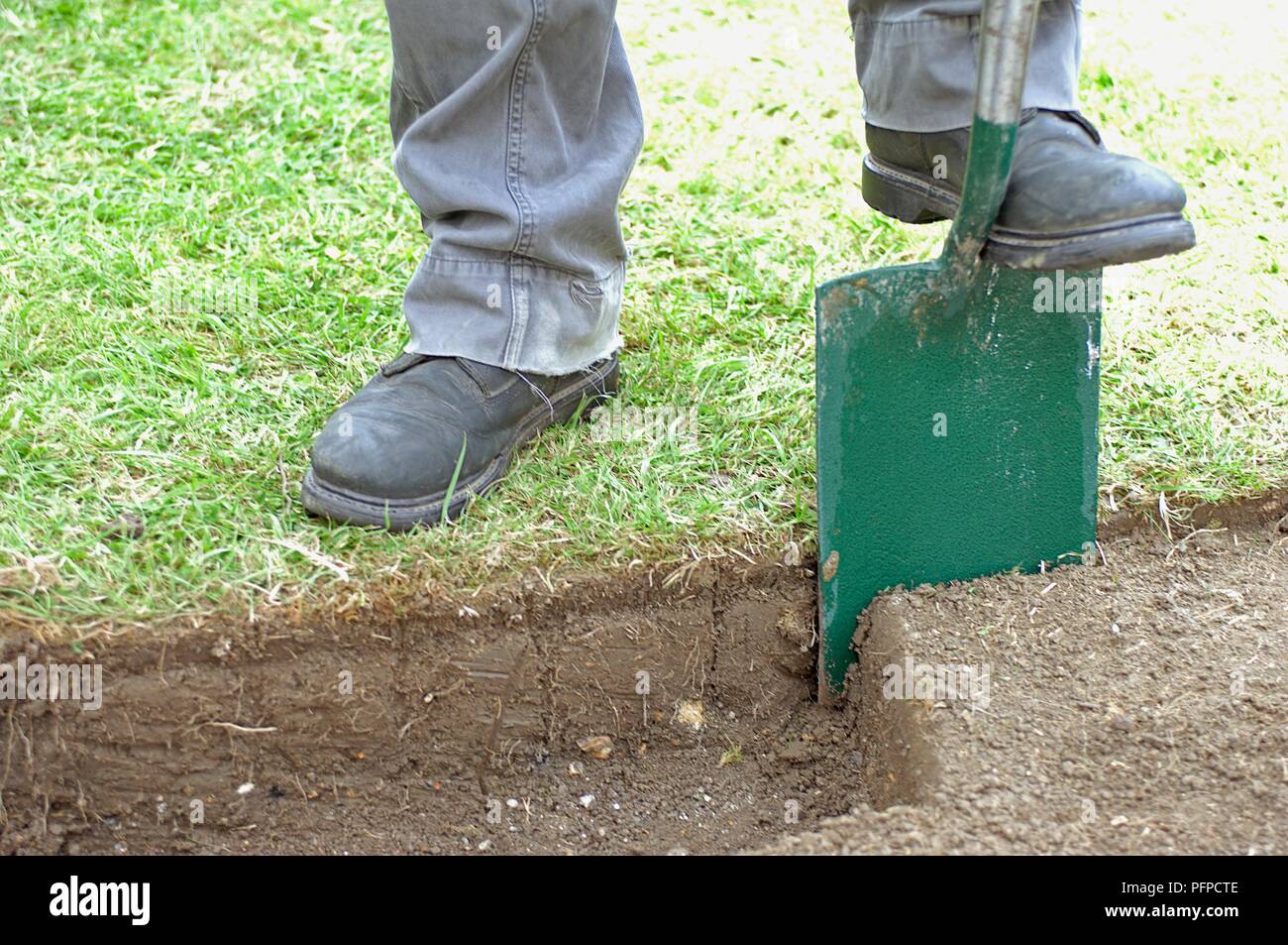Man using spade to remove turf and soil, close-up Stock Photo - Alamy