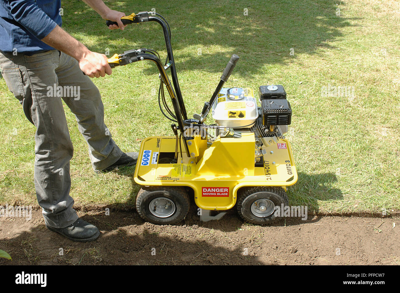 Man using plate compactor Stock Photo - Alamy