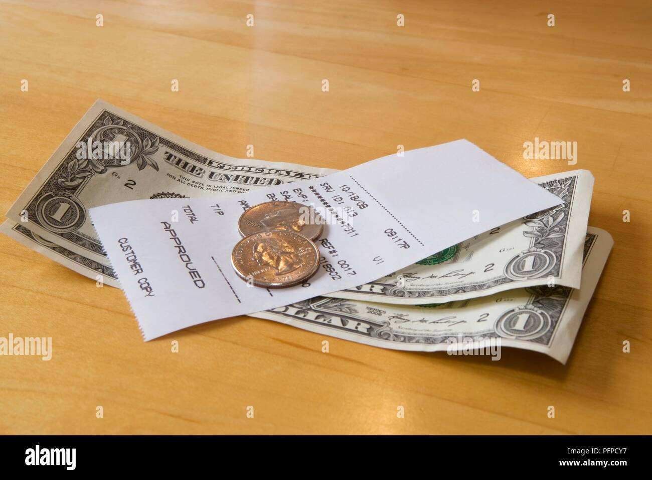 USA, dollar notes, US coins, and receipt on table Stock Photo - Alamy