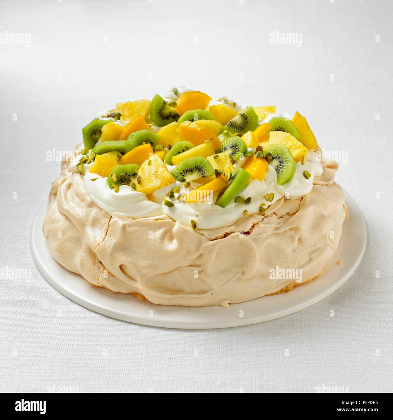 Tropical fruit pavlova on white plate Stock Photo - Alamy