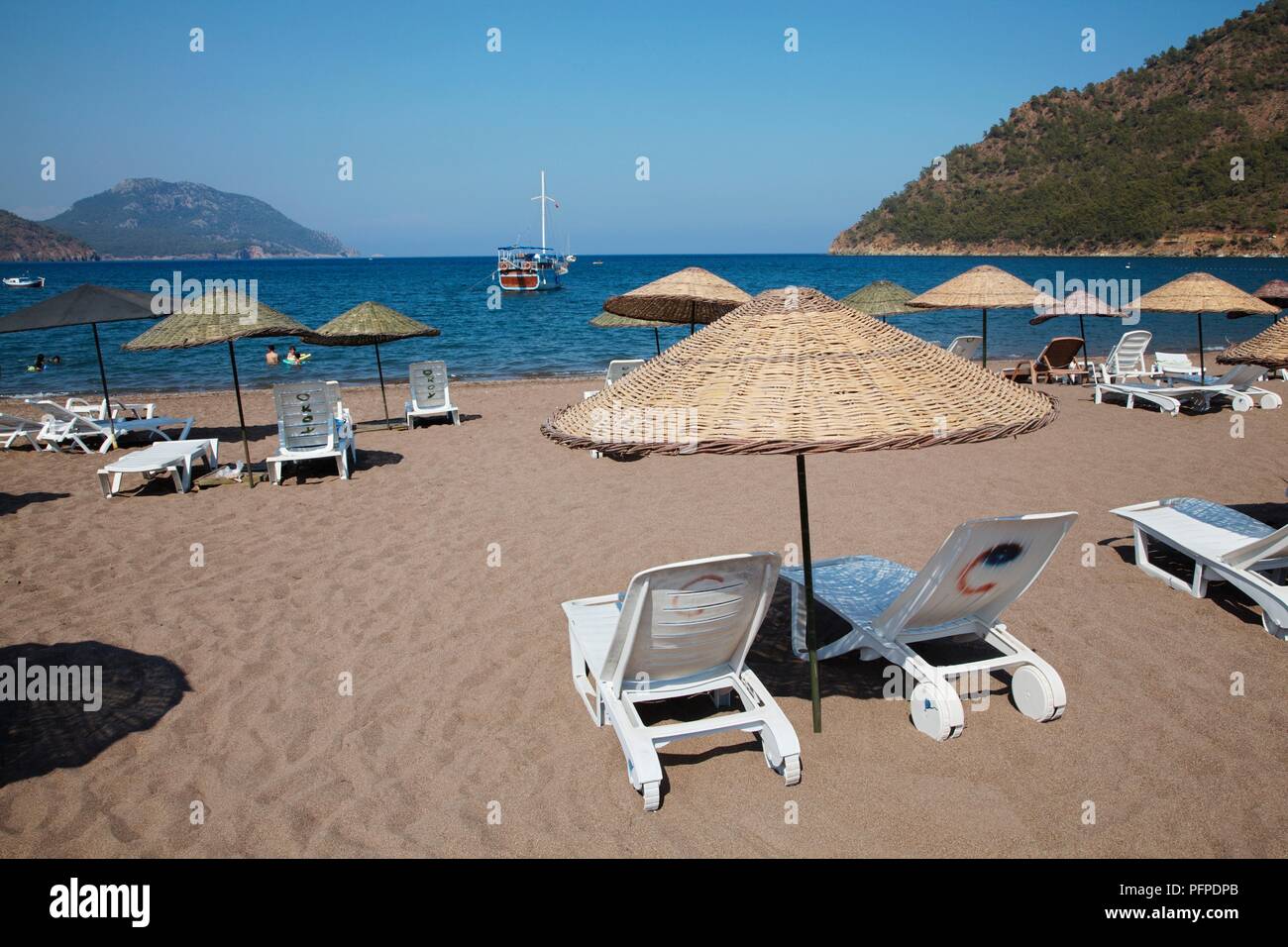 Turkey, sun loungers and palapas on Adrasan beach, near Kemer Stock ...