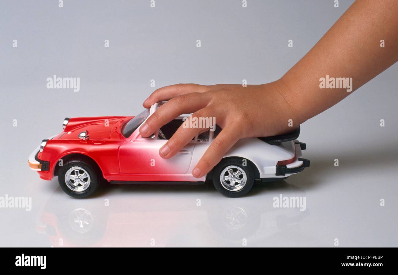 Hand holding toy car hi-res stock photography and images - Alamy