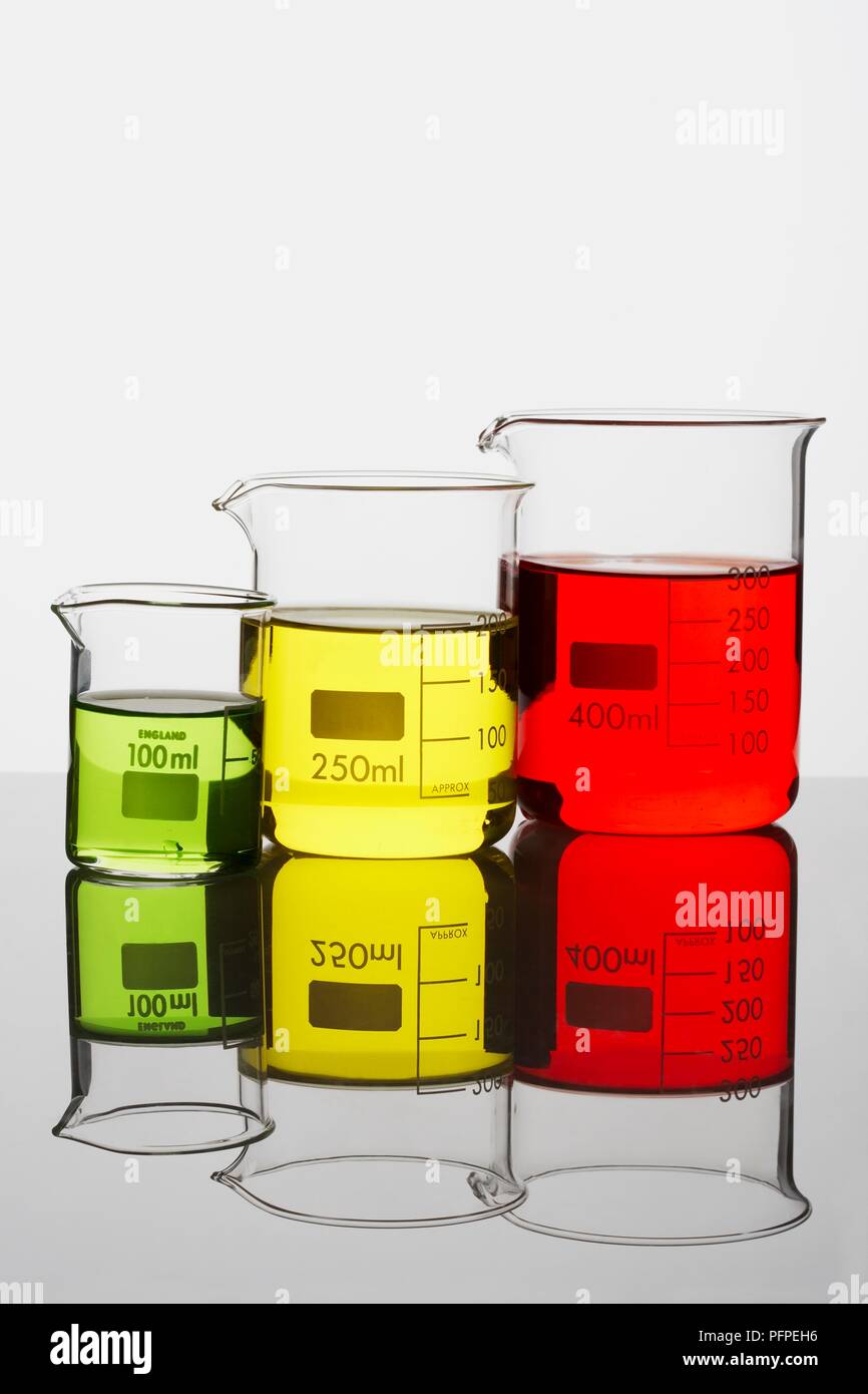 Three beakers filled with different coloured liquids Stock Photo - Alamy