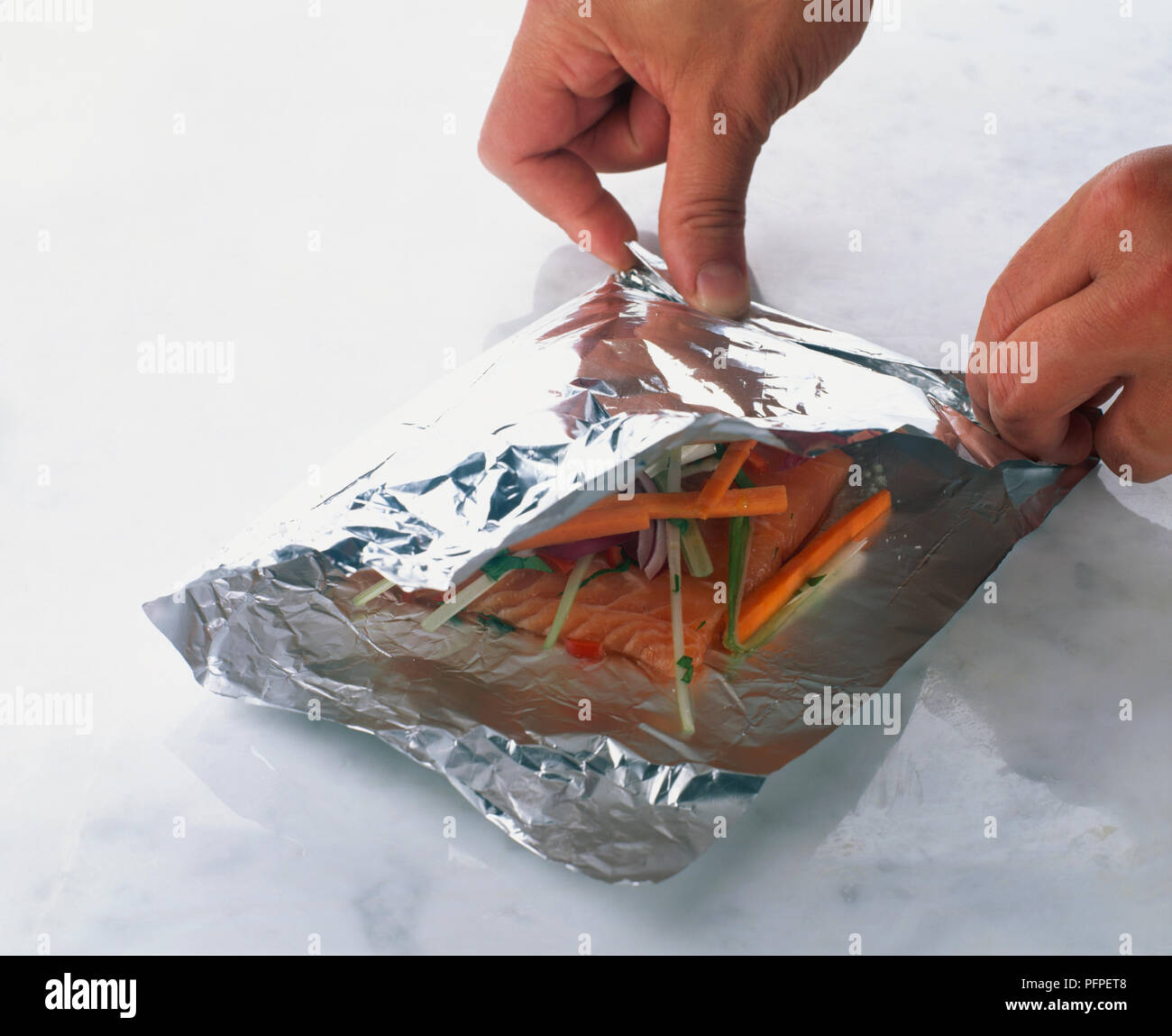 Fish wrapped in foil hi-res stock photography and images - Alamy