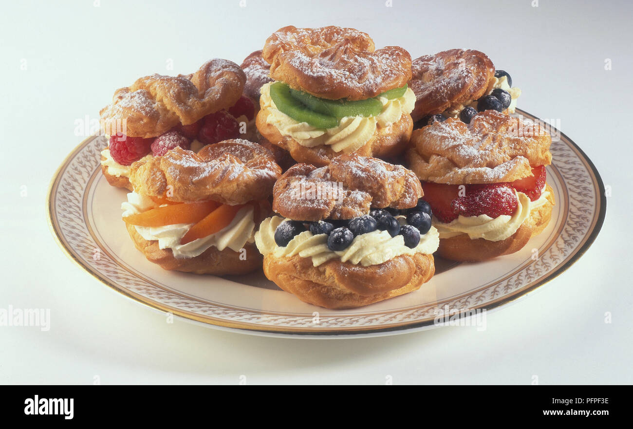 Fruit and and cream choux pastry puffs on plate Stock Photo - Alamy