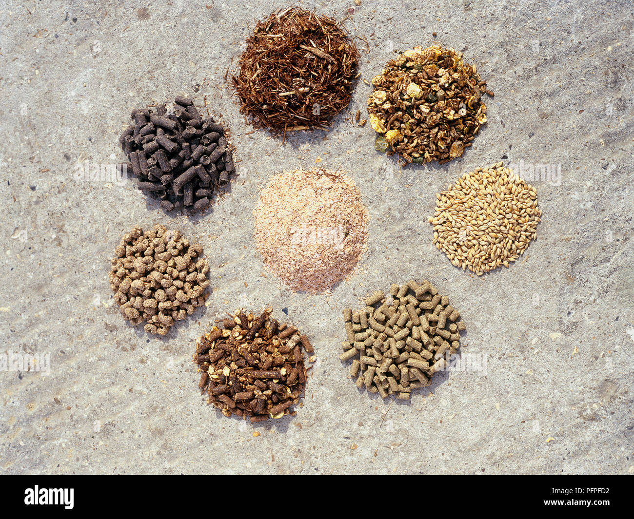 Heaps of dry horse and pony food on ground Stock Photo - Alamy