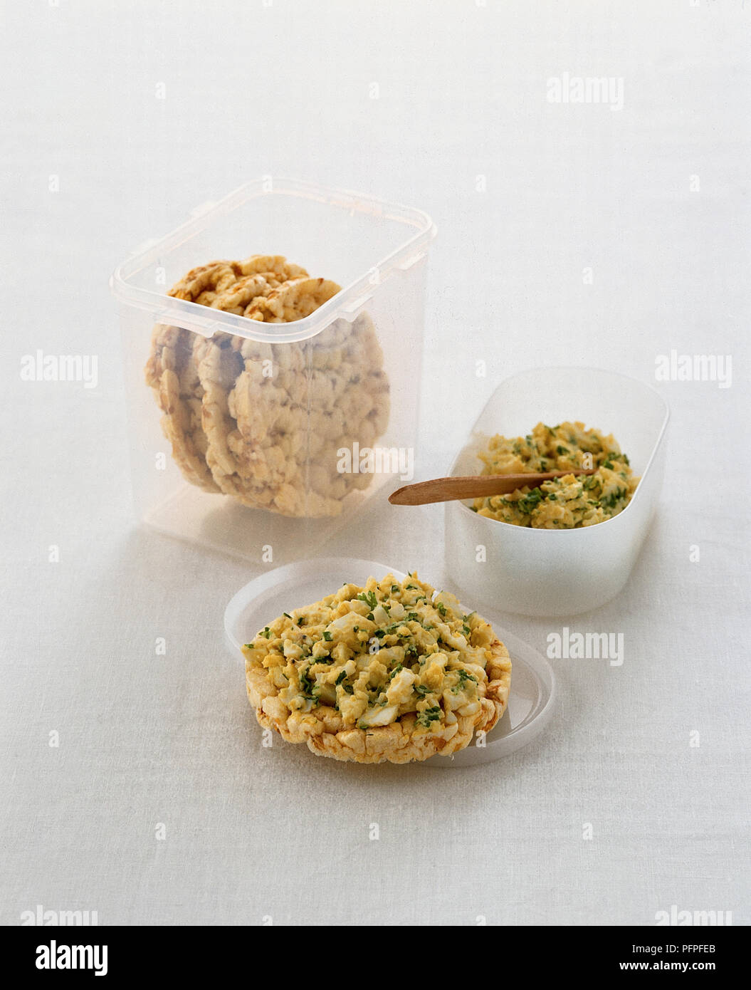 Rice cakes with egg and herb topping, in plastic containers Stock Photo ...