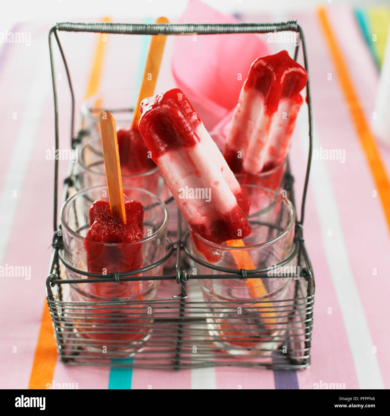 Ice lollipops standing in glasses stored in metal holder Stock Photo ...