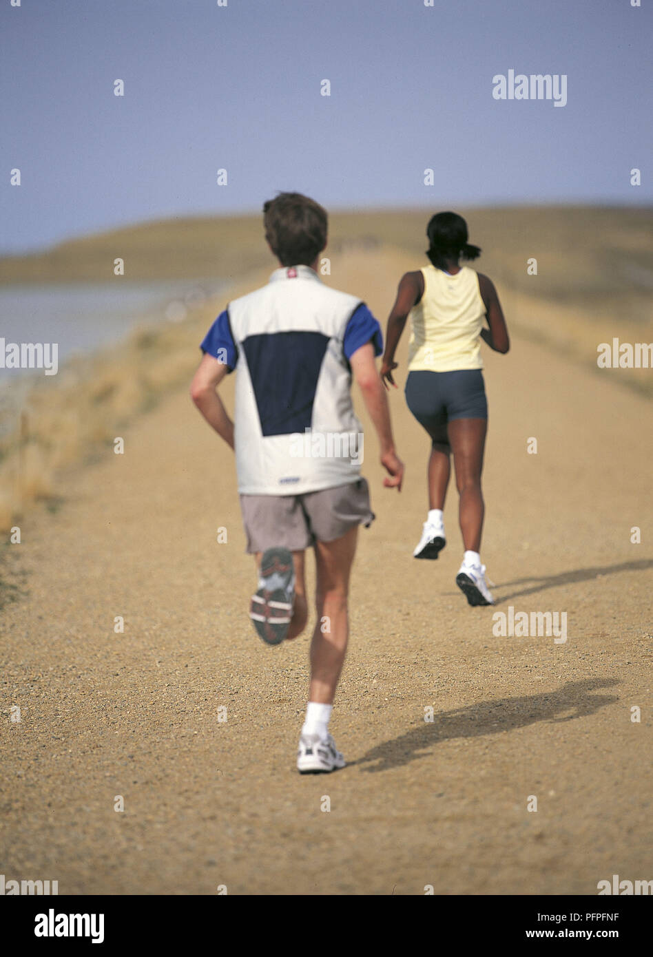 Young woman running along lake hi-res stock photography and images - Alamy