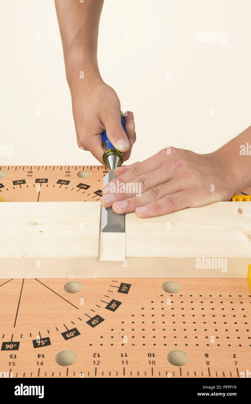 Person cutting section from wood using chisel Stock Photo - Alamy
