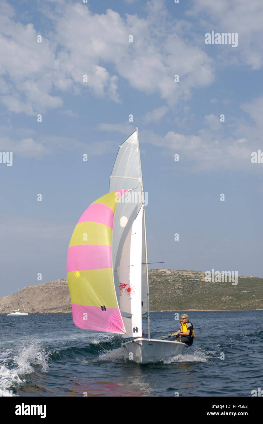 Spain, Minorca, two young women in sailing dinghy, sailing upwind Stock ...