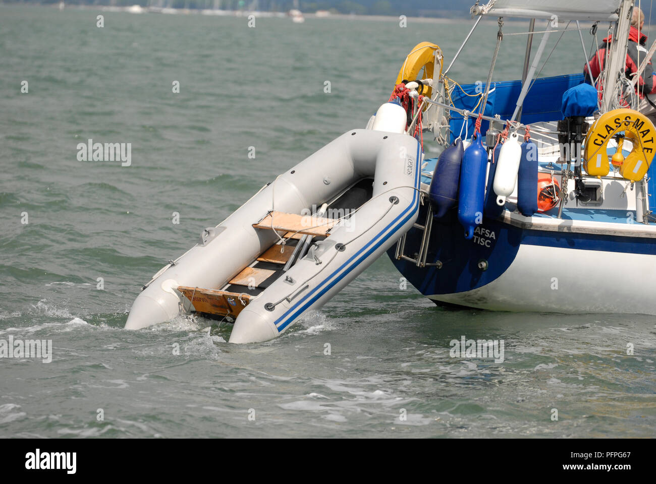 Sailing boat with tender and fenders Stock Photo - Alamy