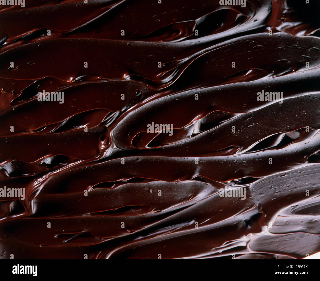 Melted dark chocolate forming pattern, close-up Stock Photo - Alamy