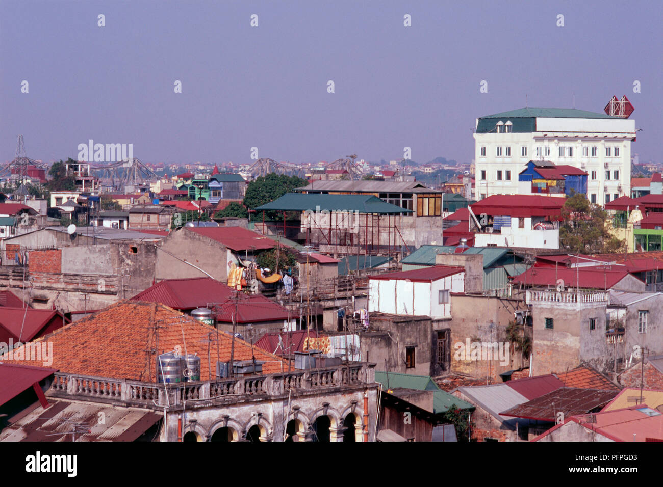 Vietnam, Hanoi, Old Quarter, city rooftops and large white building ...