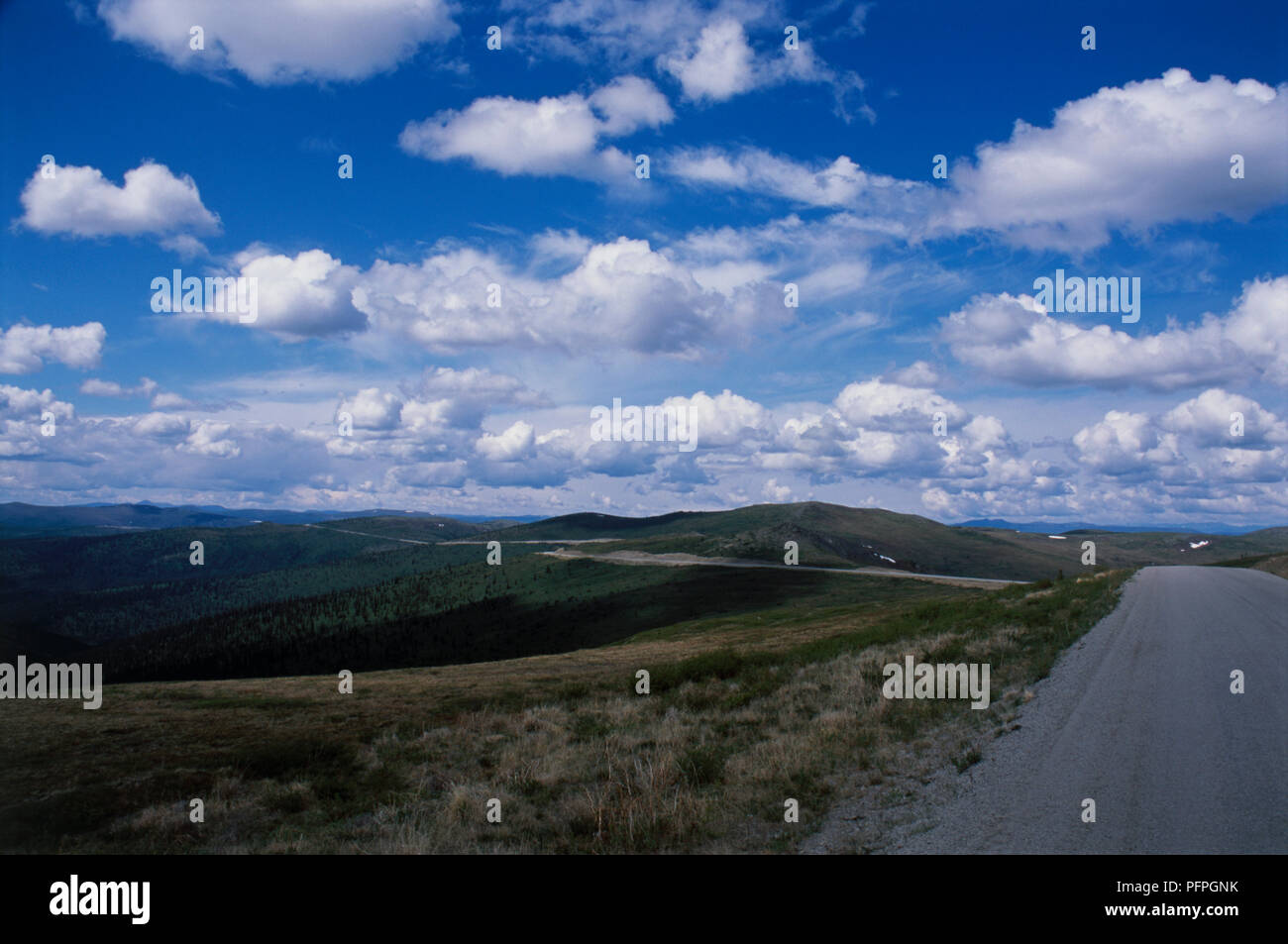 Canada, Yukon Territory, cloudscape in blue sky above Top of the World ...