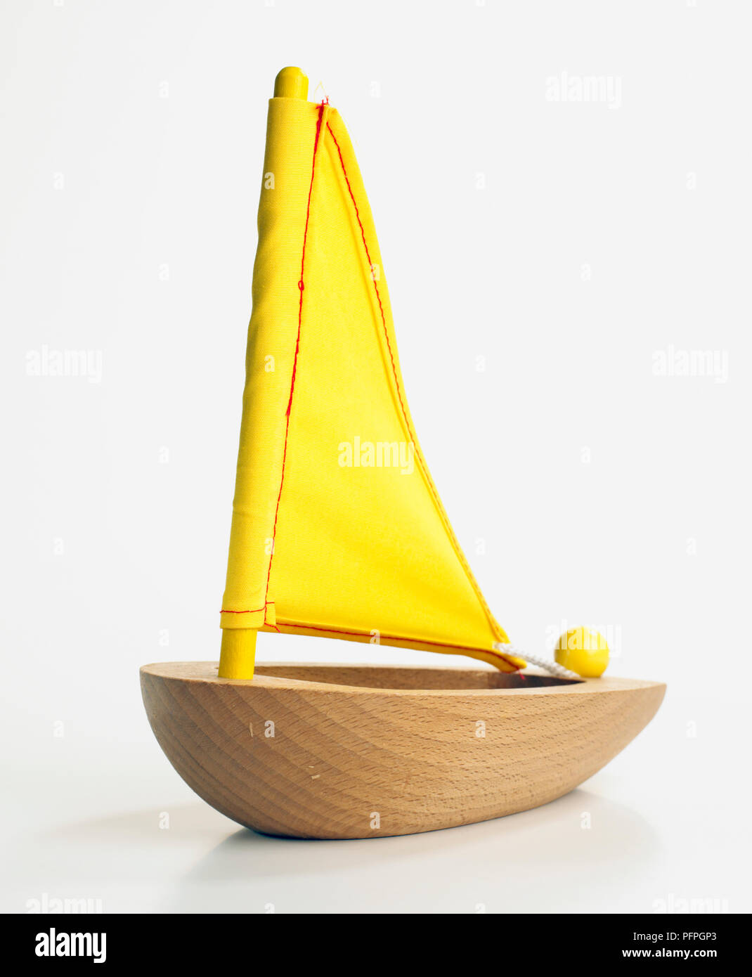 Toy boat with yellow sail Stock Photo - Alamy