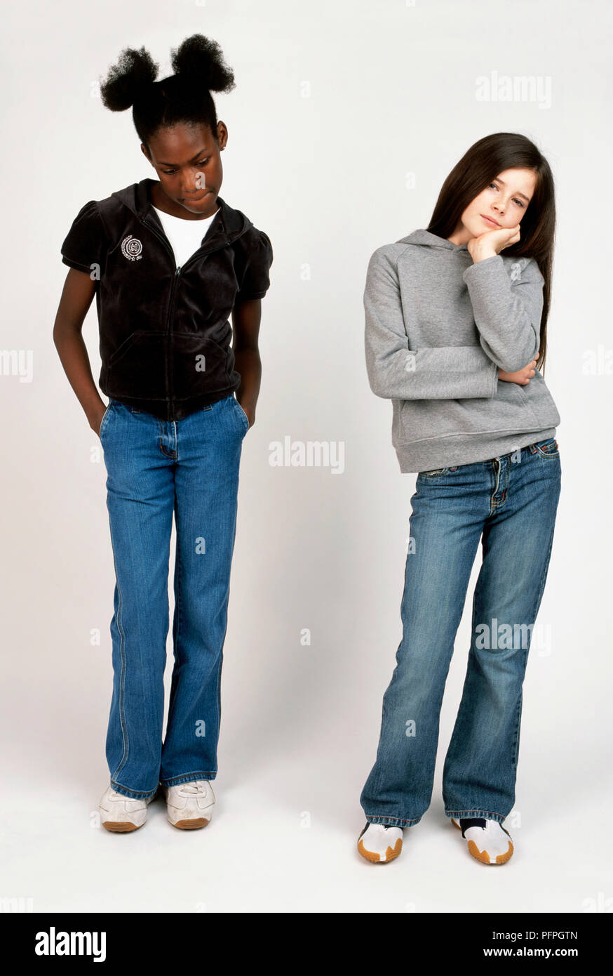 Girls Standing With One Arm Across Body And One Under Her Chin And Standing With Hands In