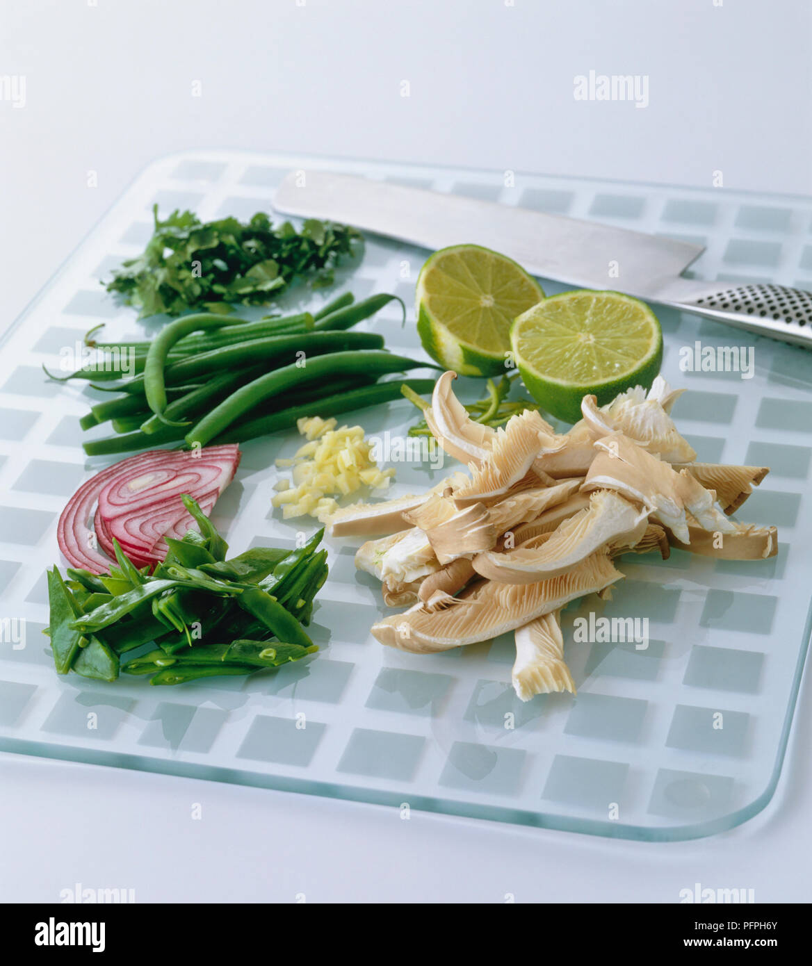 Ingredients on glass chopping board with kitchen knife Stock Photo - Alamy