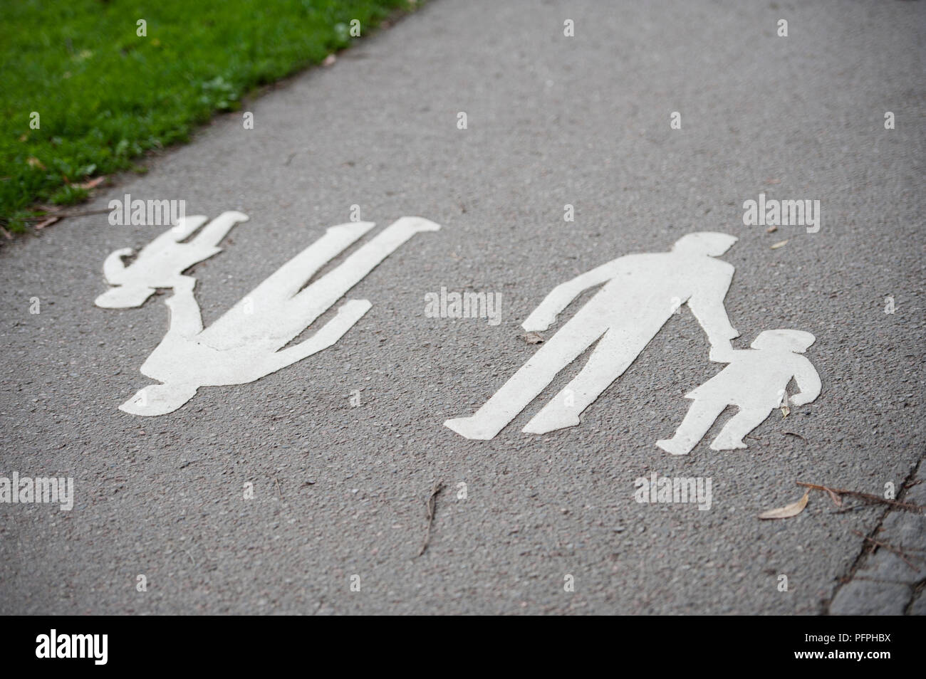 Sweden, Stockholm, child and adult holding hands sign on footpath Stock ...