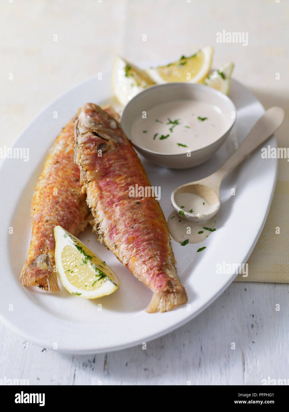 Samak Maquli, Egyptian-style fried red mullet served on platter with ...