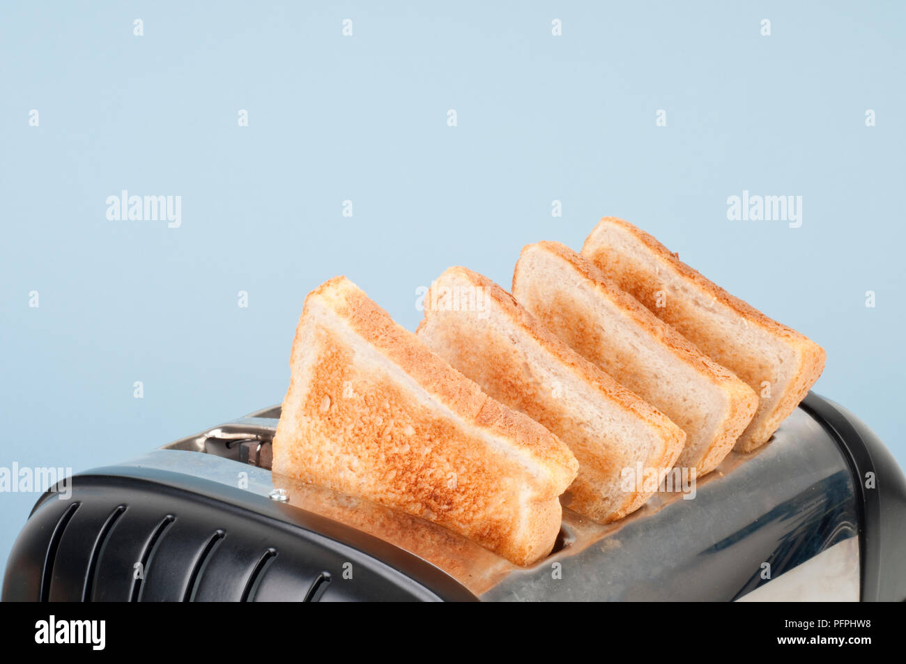 Four slices of white toast in four-slot toaster, close-up Stock Photo ...