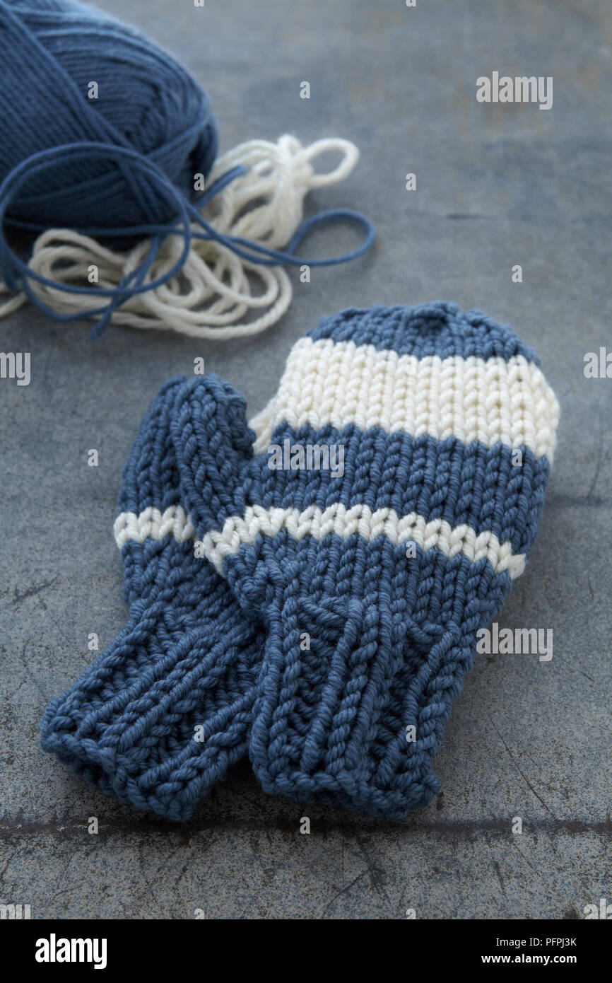 Child's blue and white striped mittens Stock Photo - Alamy