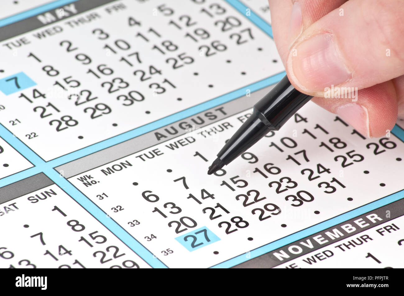 Person holding felt-tip pen over calendar Stock Photo - Alamy